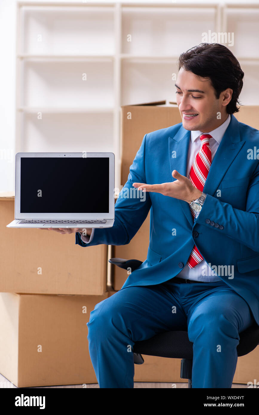 Young handsome businessman moving to new workplace Stock Photo - Alamy