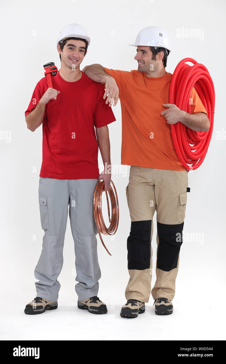 Two plumbers stood together Stock Photo - Alamy