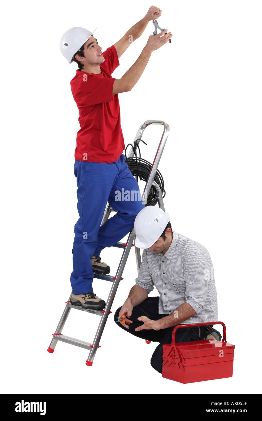 Two electricians working together Stock Photo - Alamy