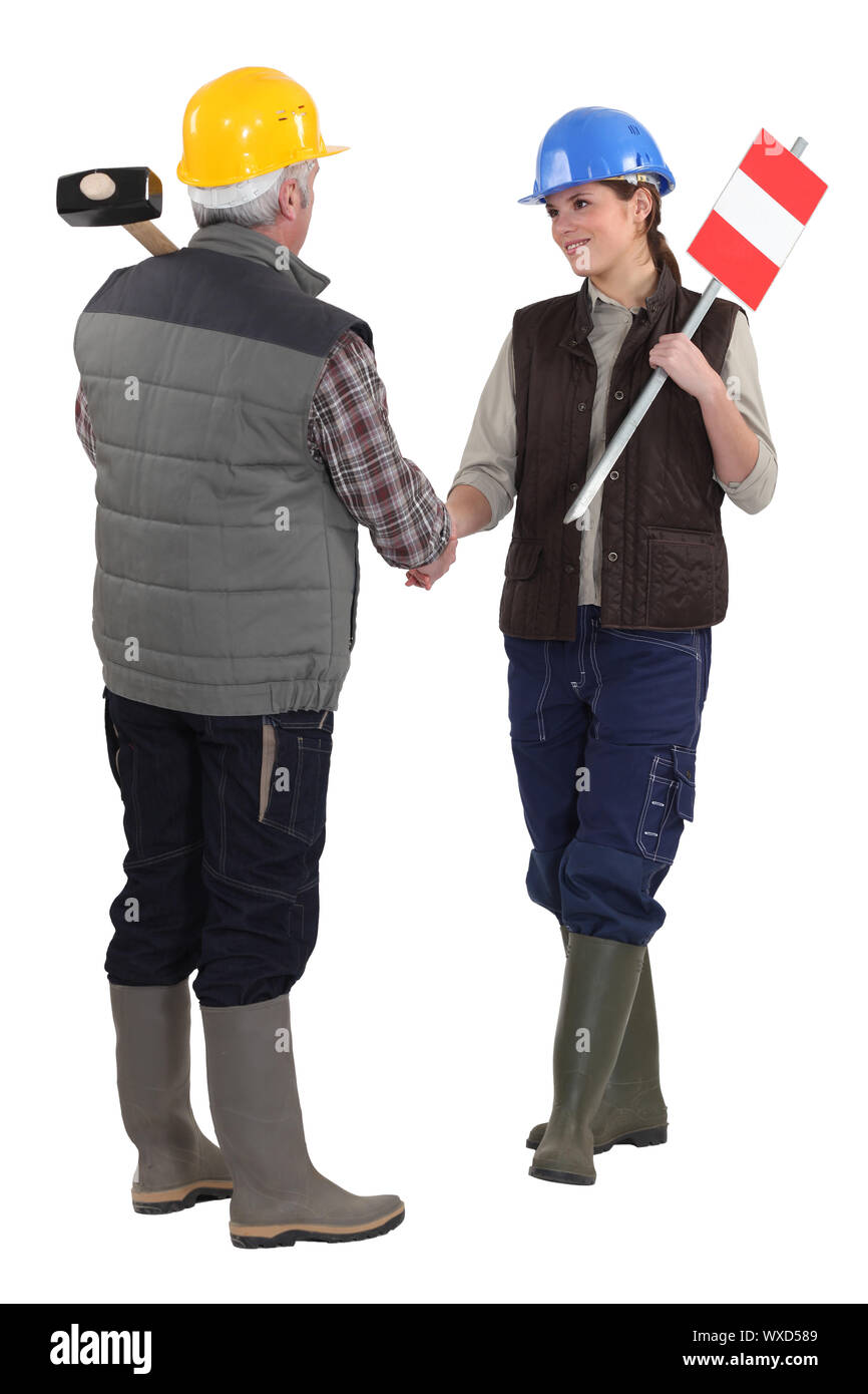 Tradespeople shaking hands Stock Photo - Alamy