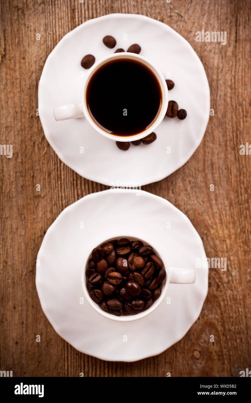 two cups full of coffee on wooden background Stock Photo - Alamy