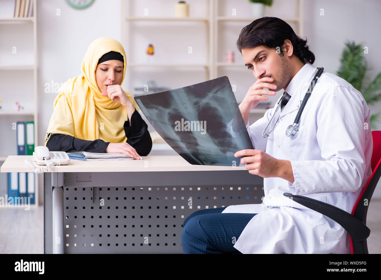 Female arab patient visiting male doctor Stock Photo - Alamy