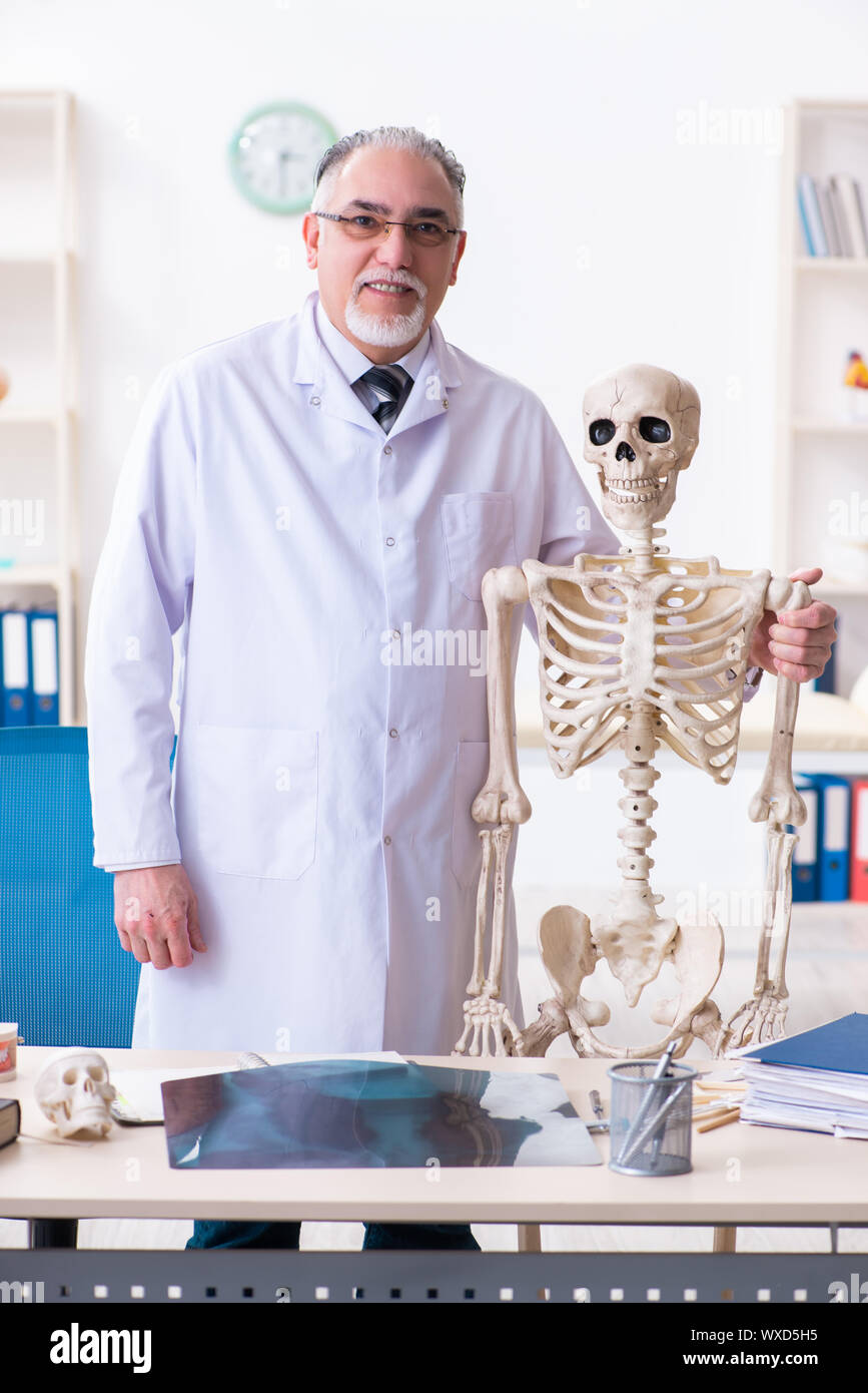 Aged male doctor with skeleton Stock Photo - Alamy