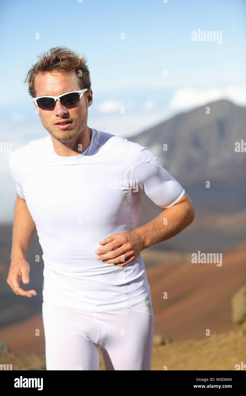 Running man. Male runner jogging outside in mountain landscape doing ...