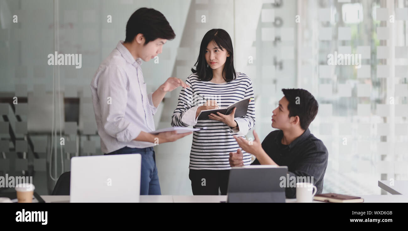 Group of young professional startup team discussing their new project ...