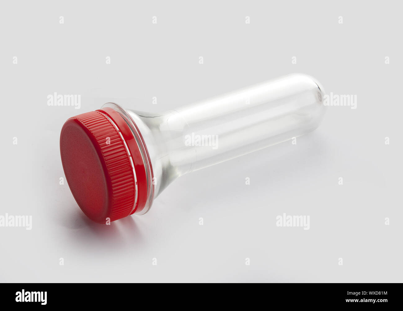 Plastic bottle preform with red cap on the grey background Stock Photo ...