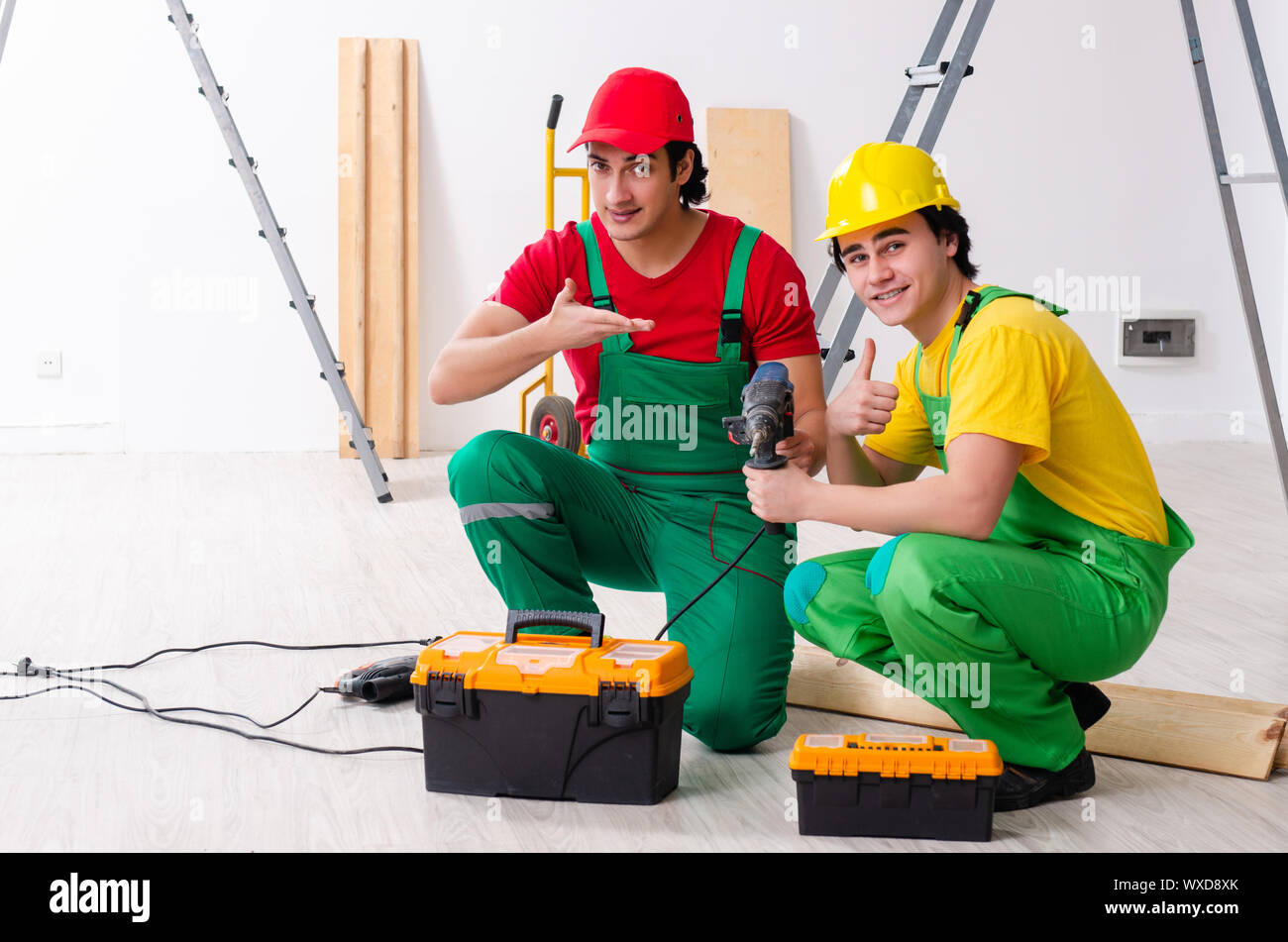Two workers contractors working indoors Stock Photo - Alamy