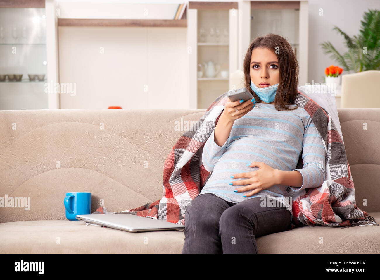 Sick pregnant woman suffering at home Stock Photo - Alamy
