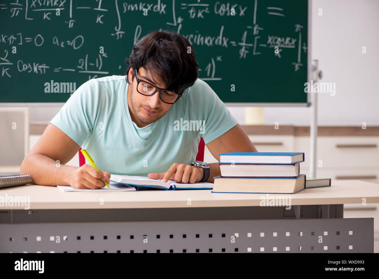 Young male student mathematician in front of chalkboard Stock Photo - Alamy