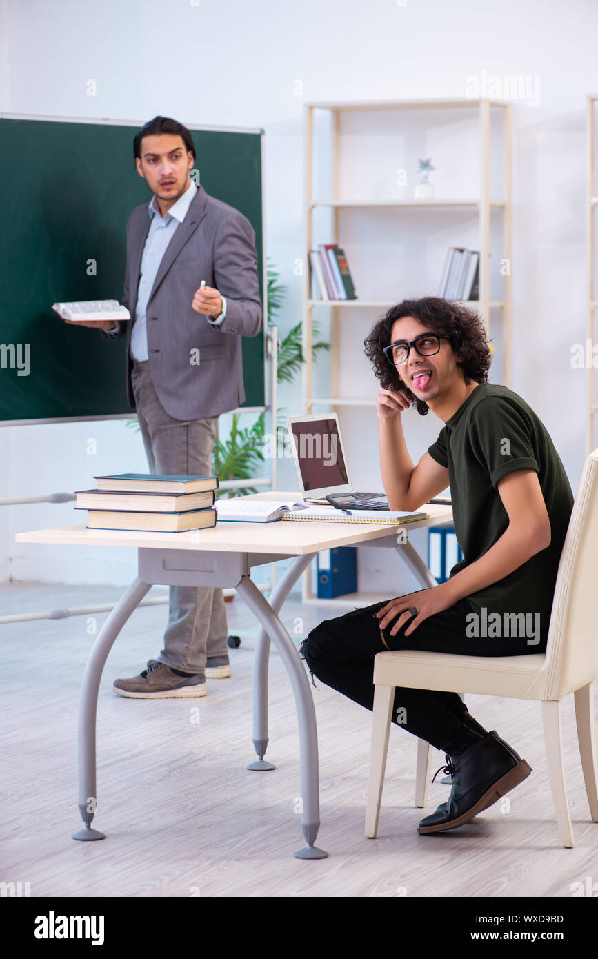Young teacher and student in the classroom Stock Photo - Alamy