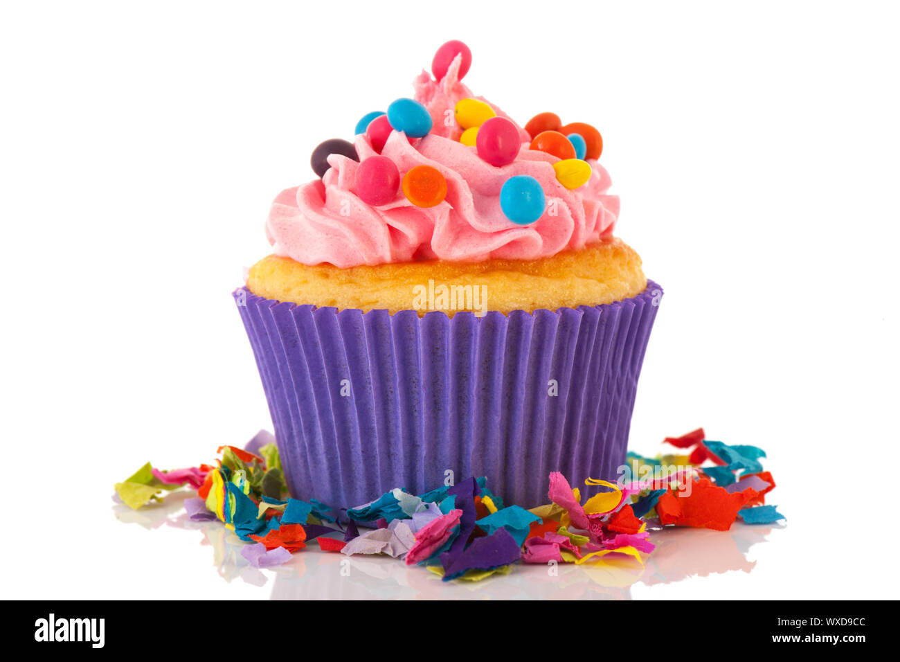 Birthday cupcake with confetti and pink buttercream isolated over white ...