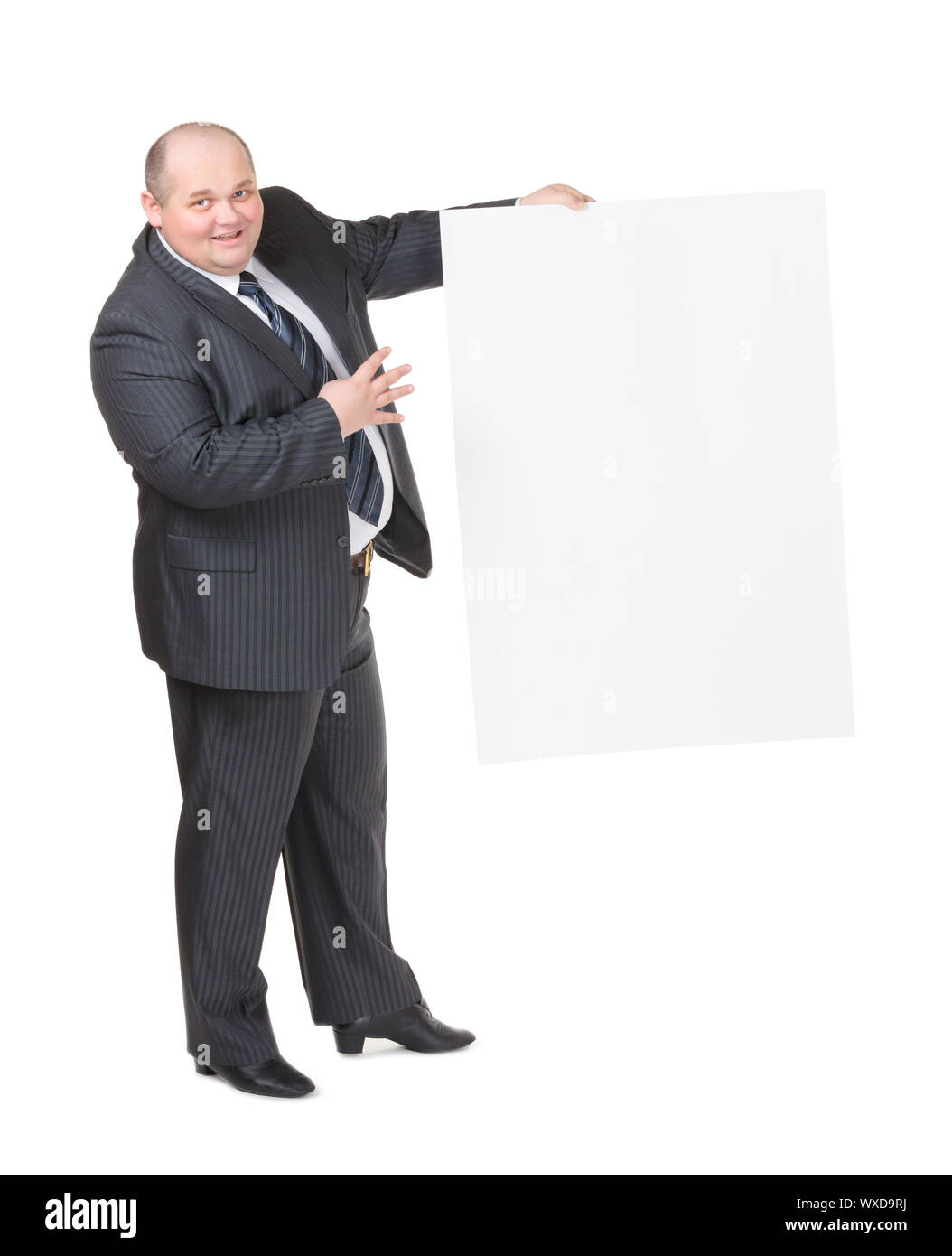 Cheerful overweight stylish business man in a suit holding up a blank ...