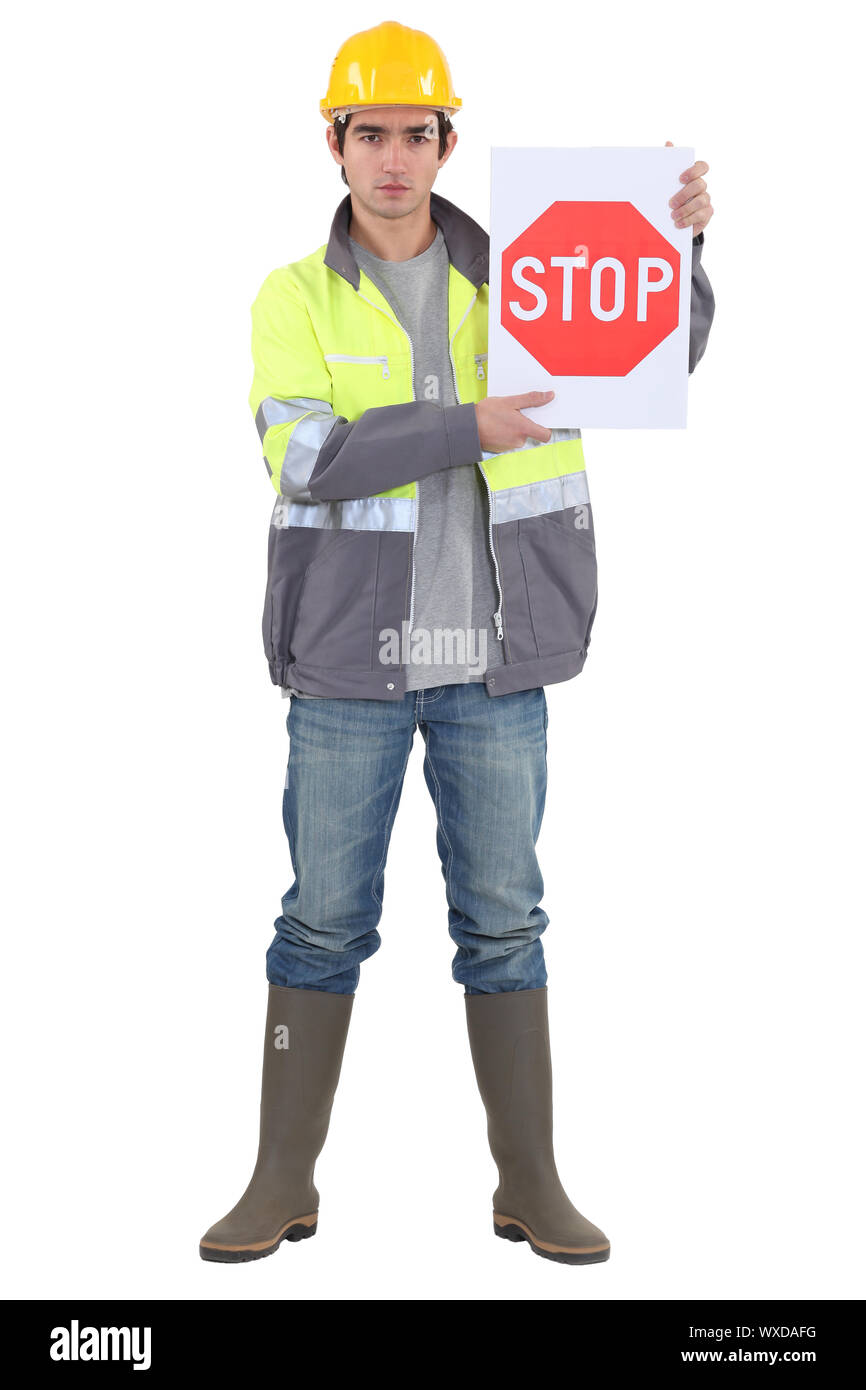 Workman holding stop sign hi-res stock photography and images - Alamy