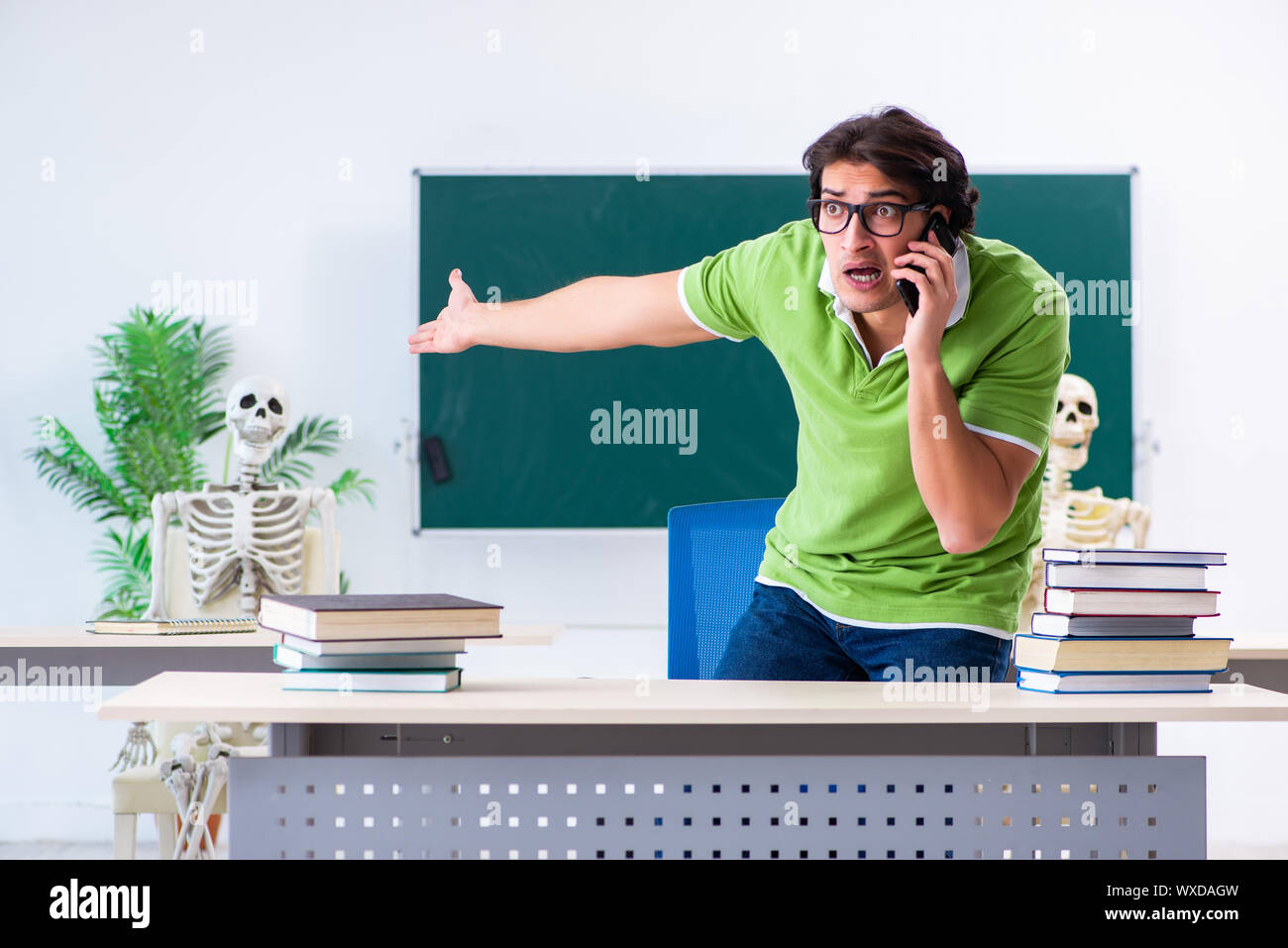 Funny male student in the classroom with skeleton Stock Photo - Alamy