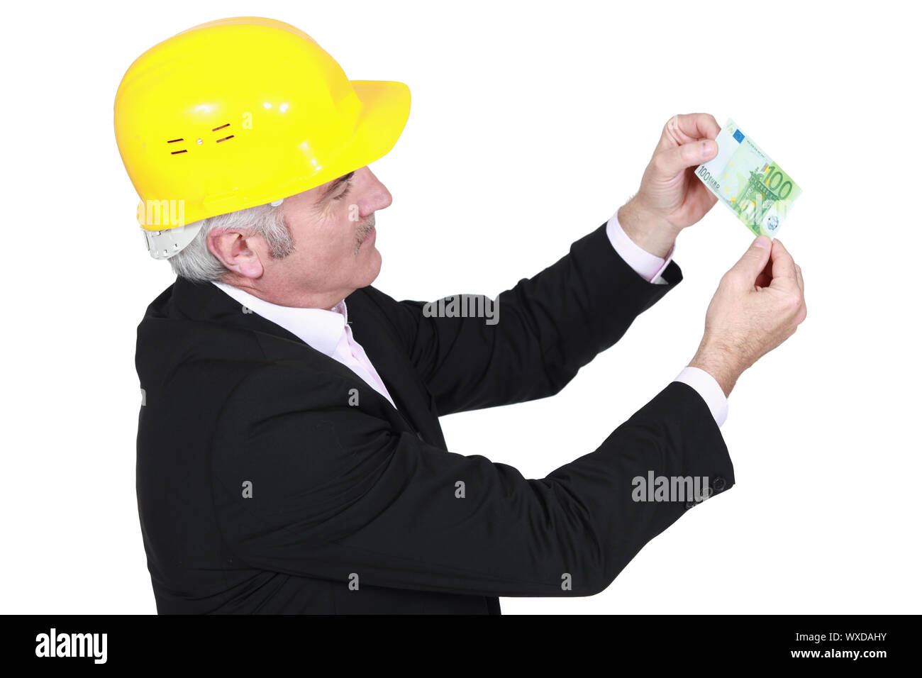 Architect with a 100 euro banknote Stock Photo - Alamy