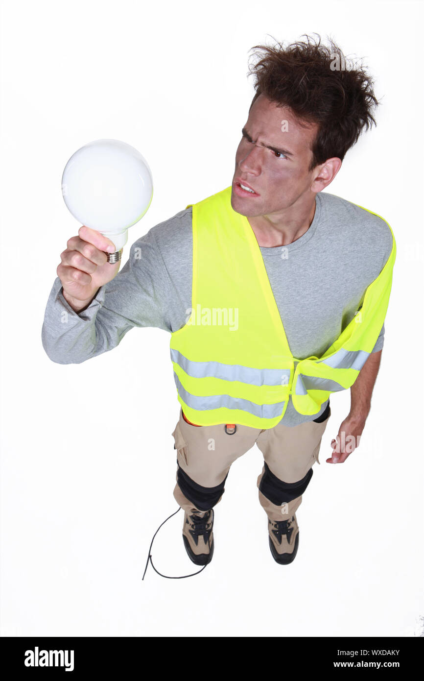Worker getting an electric shock from a light bulb Stock Photo - Alamy