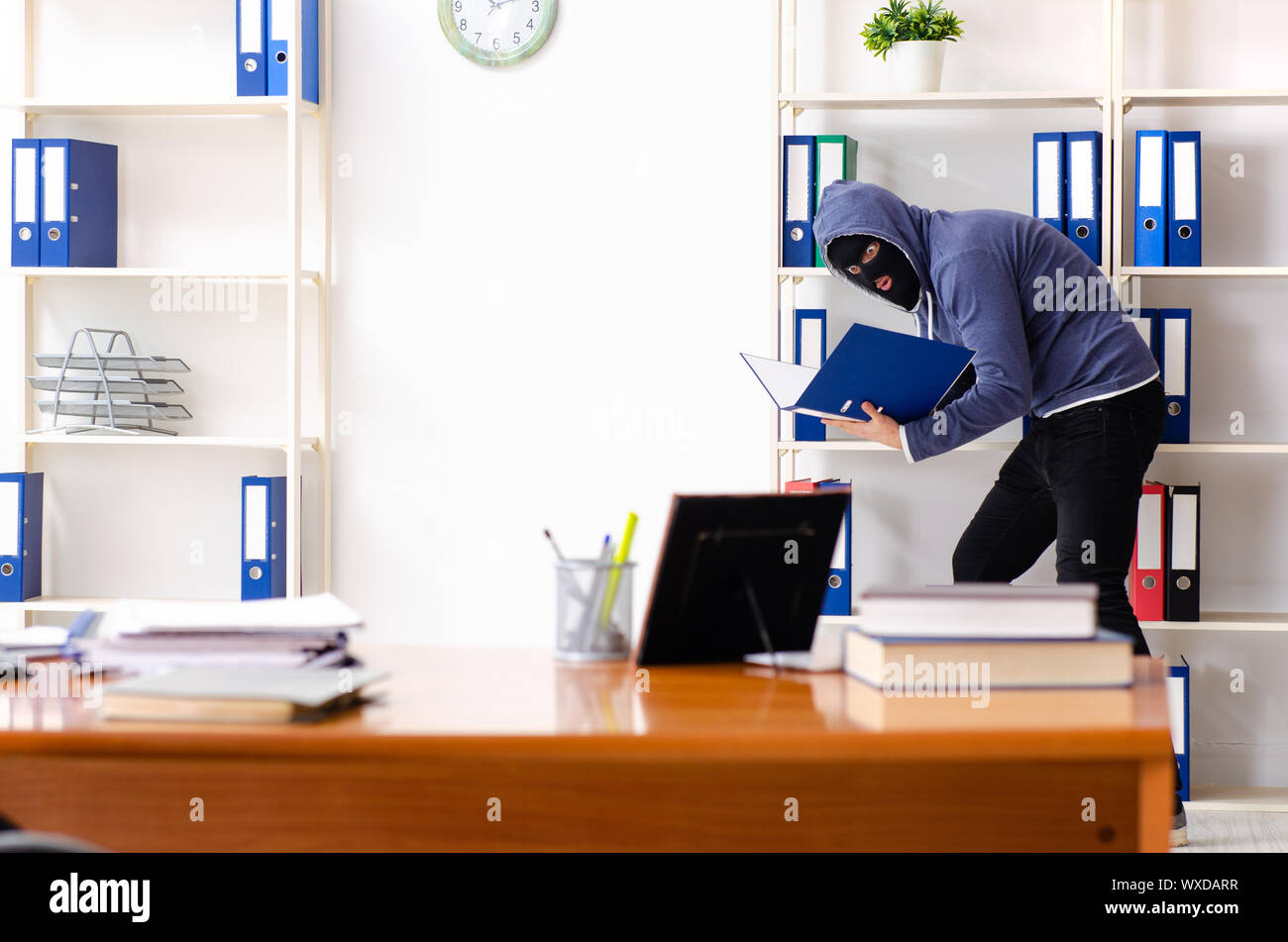 Male thief in balaclava in the office Stock Photo - Alamy