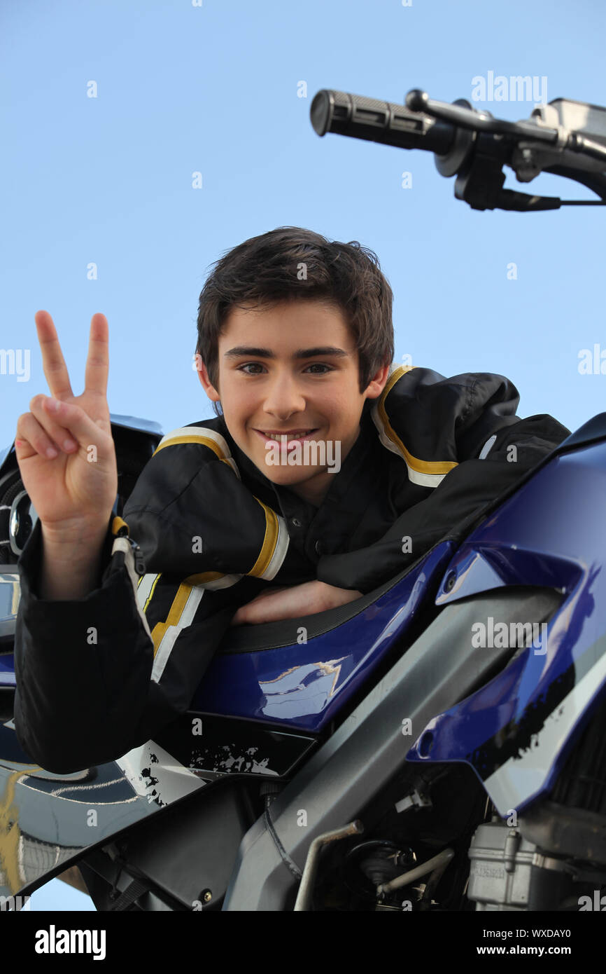 Teenager stood by his motorcycle Stock Photo - Alamy