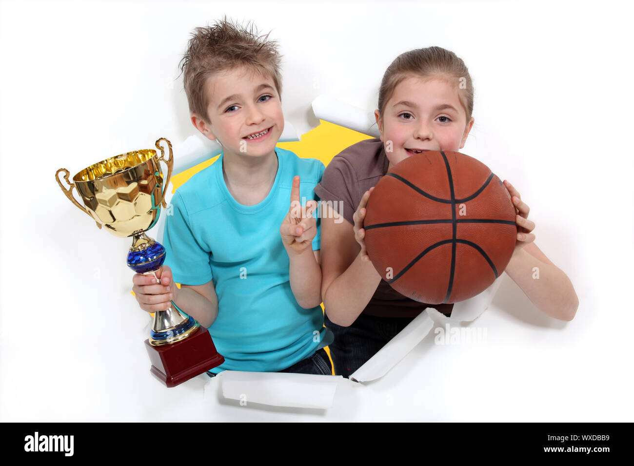 Young basketball players holding a trophy Stock Photo - Alamy