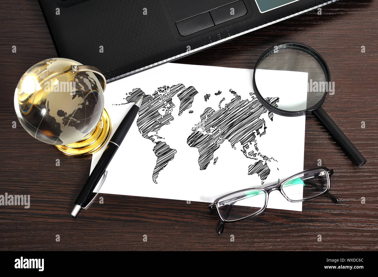 workplace with drawing world map on paper Stock Photo - Alamy