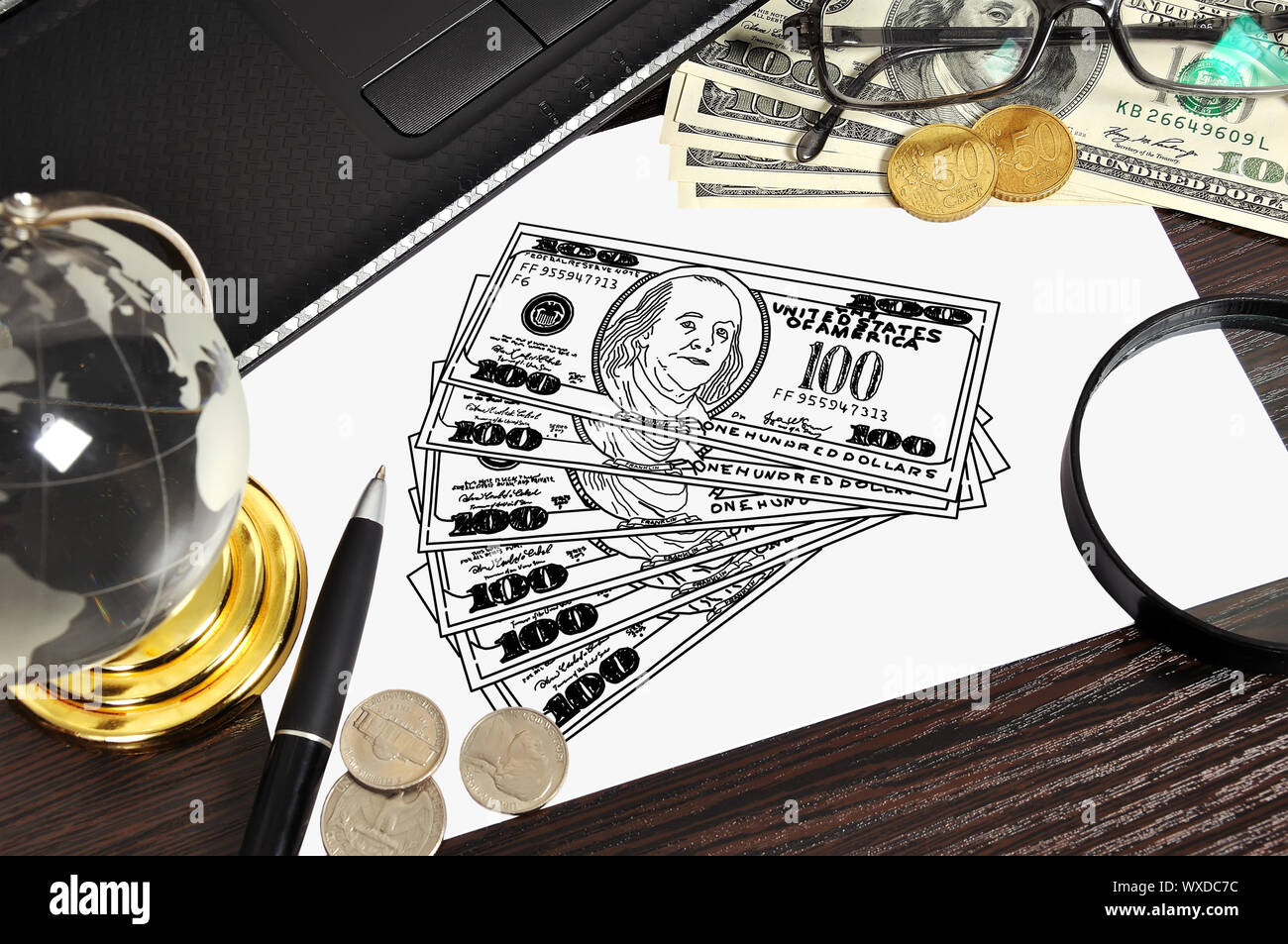 Modern workplace with drawing dollars on paper Stock Photo - Alamy
