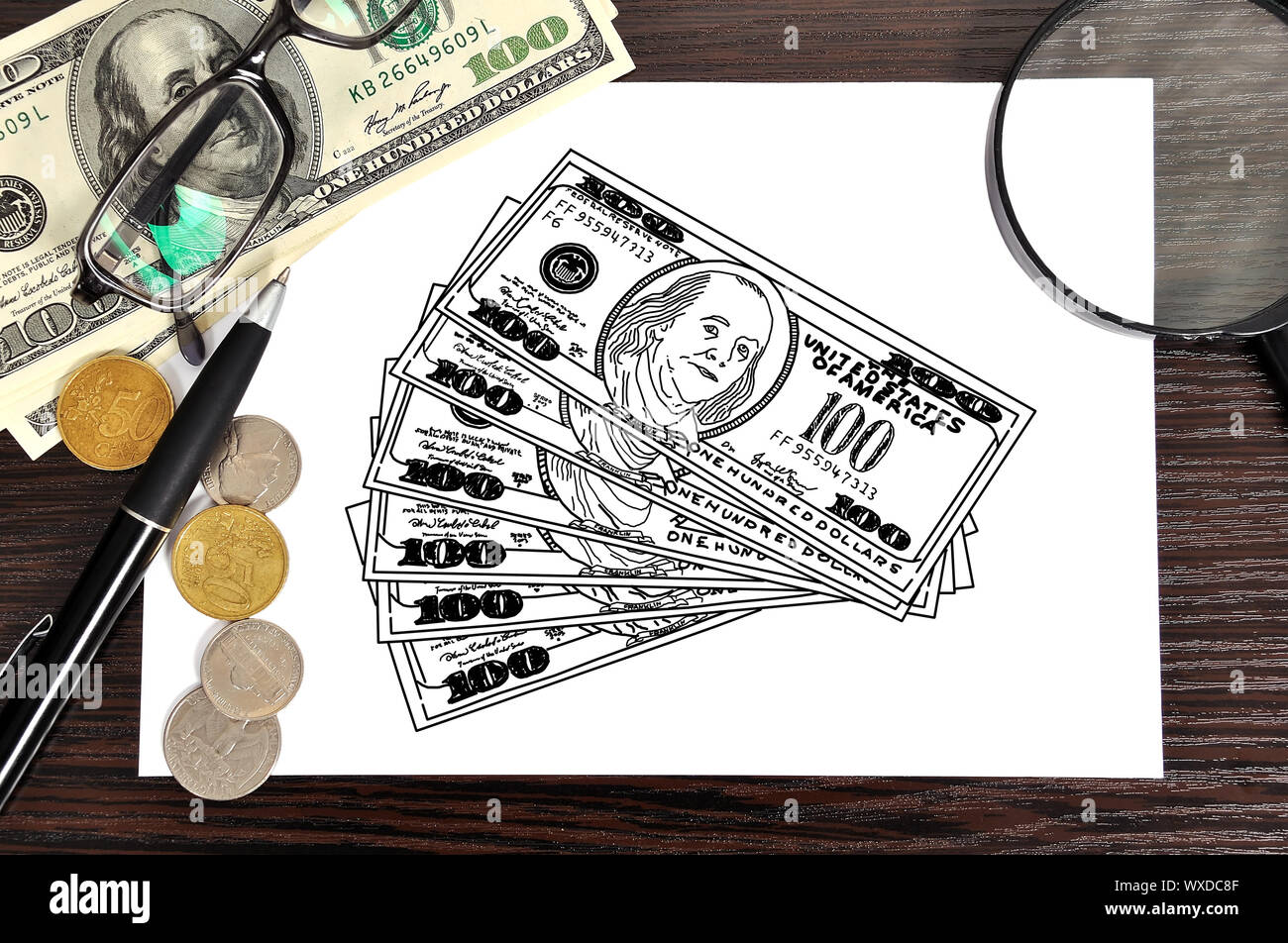 Modern workplace with drawing dollars on paper Stock Photo - Alamy