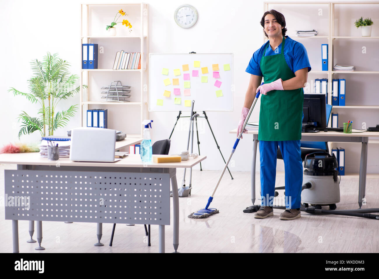 Male handsome professional cleaner working in the office Stock Photo ...