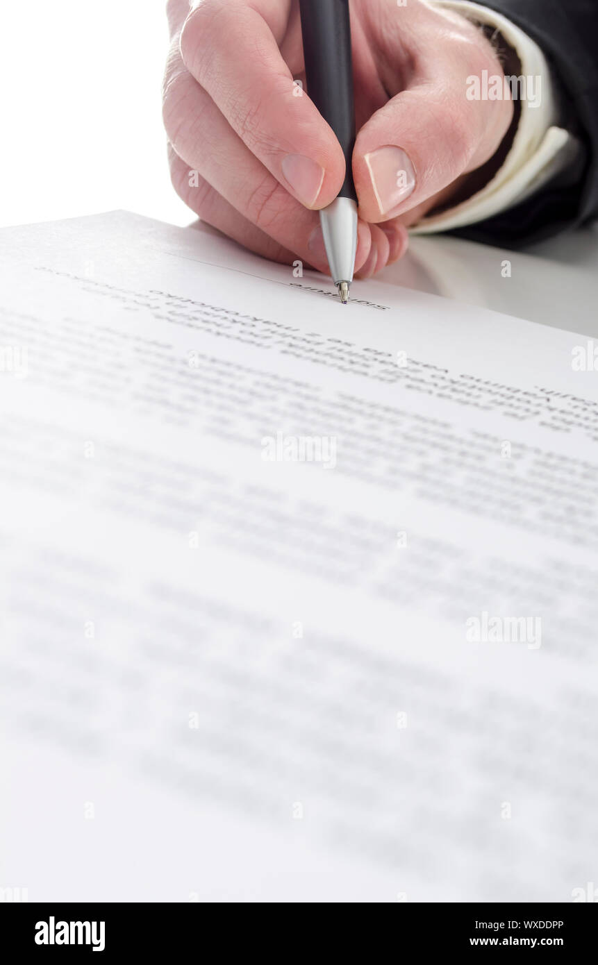 Cropped view of a businessman's hand signing a contract above signature ...