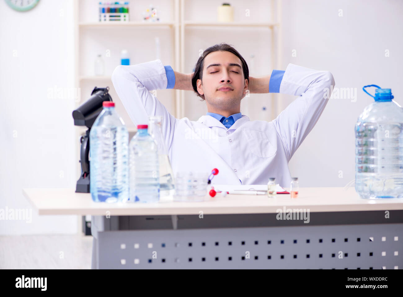 Young male chemist experimenting in lab Stock Photo - Alamy