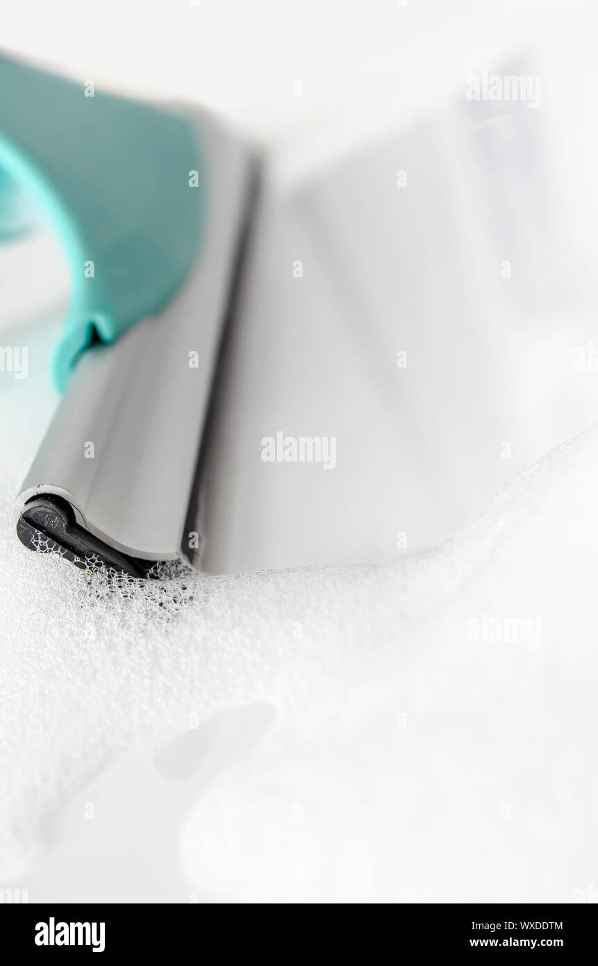 Detail of cleaning white ceramic tiles with rubber window cleaner Stock ...