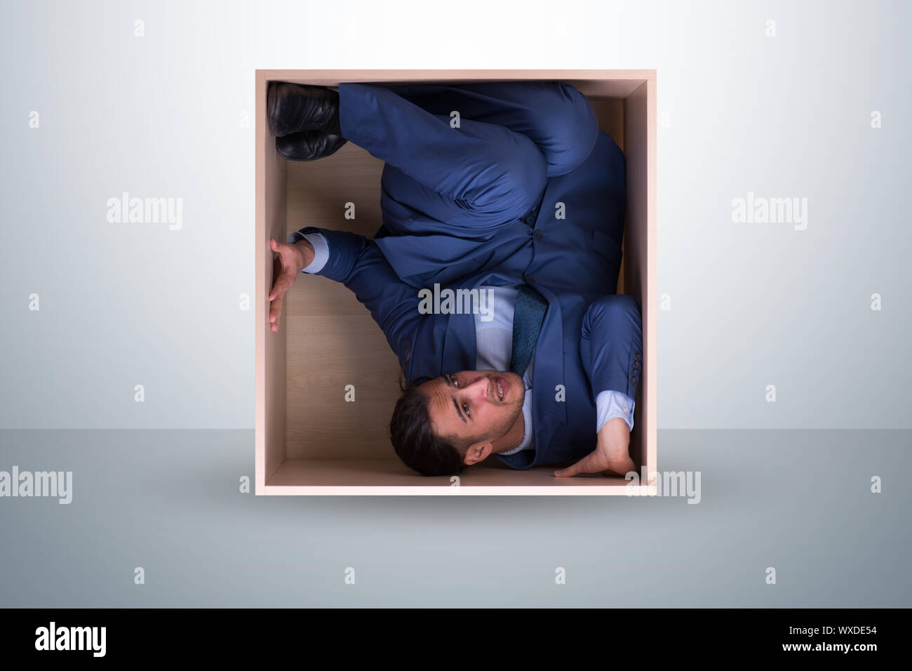 Employee working in tight space Stock Photo - Alamy