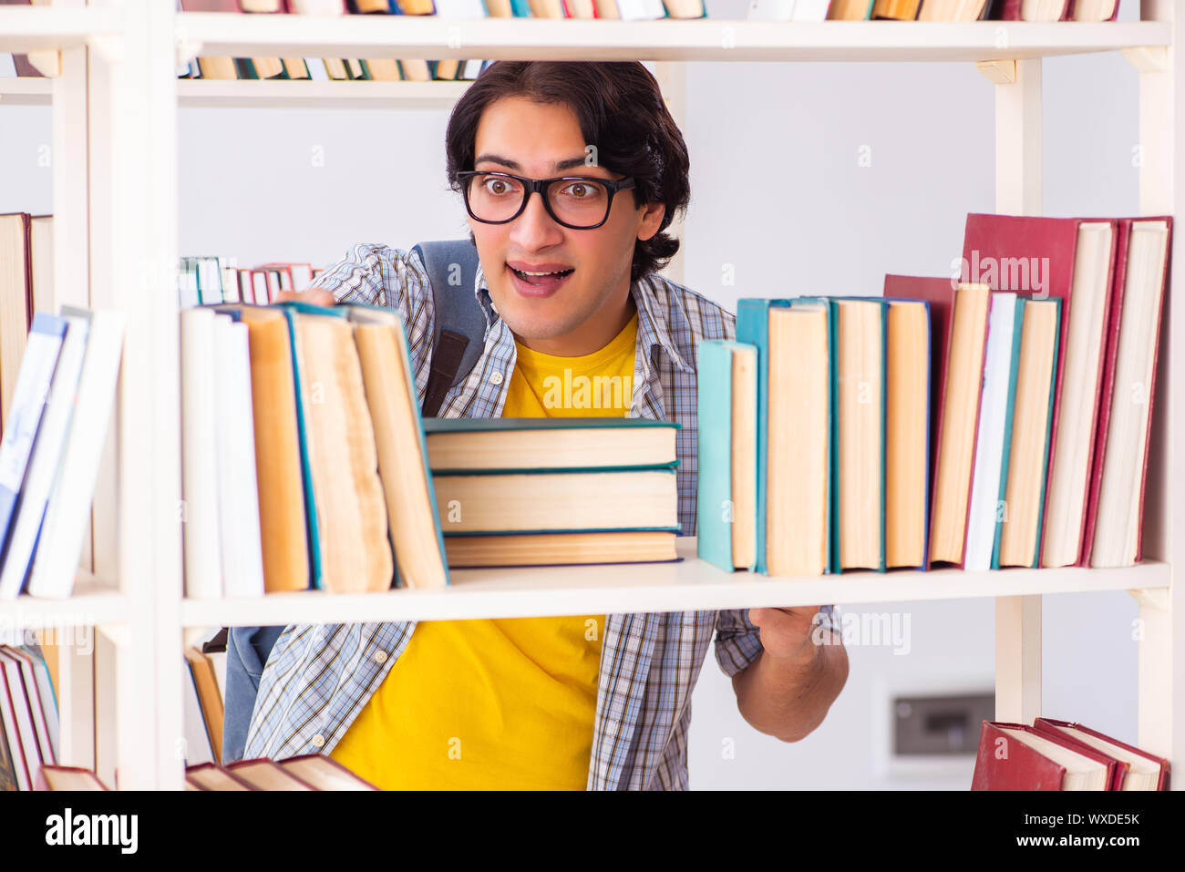Male student preparing for exams at library Stock Photo - Alamy