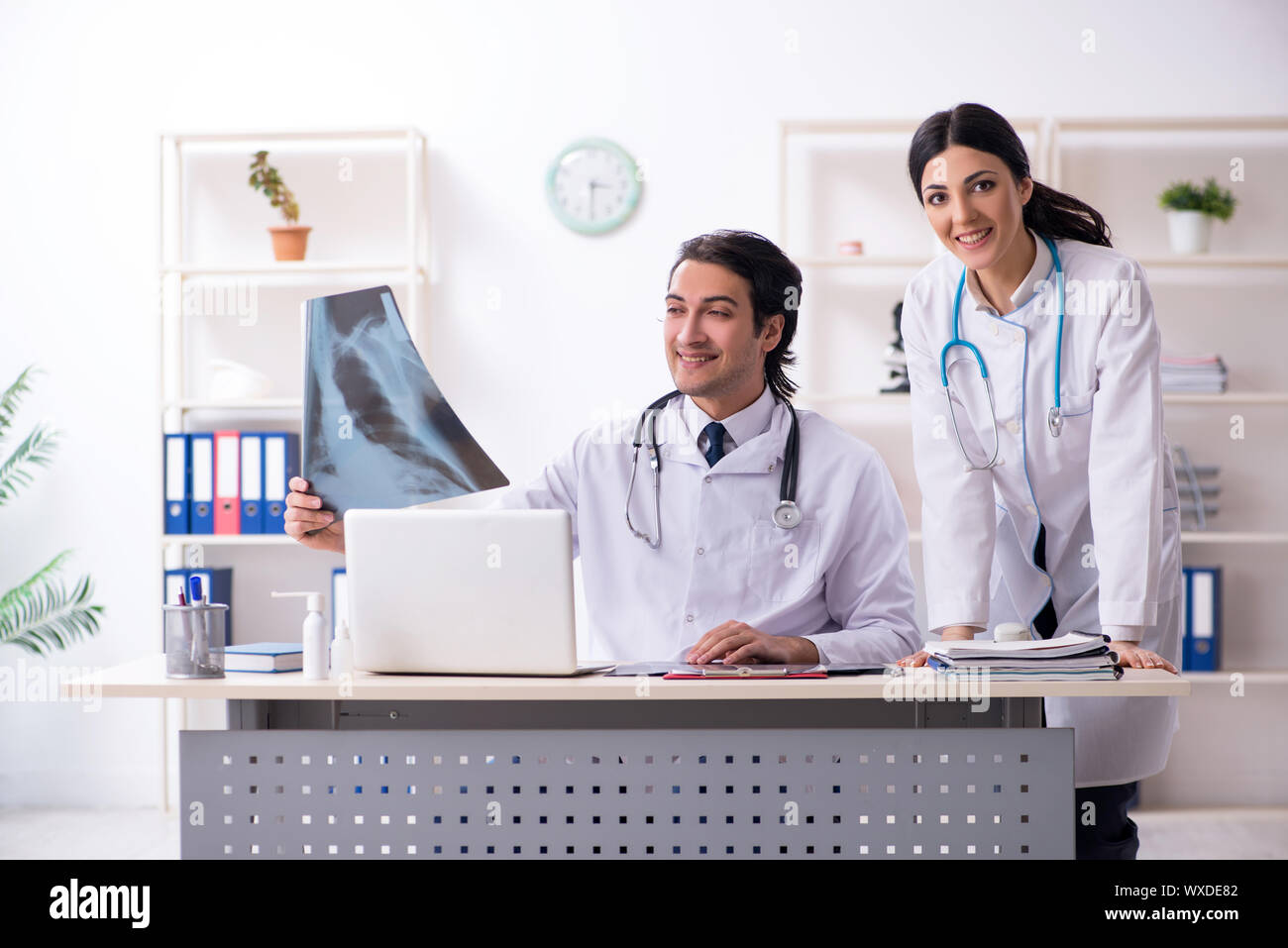 Two young doctors working in the clinic Stock Photo - Alamy