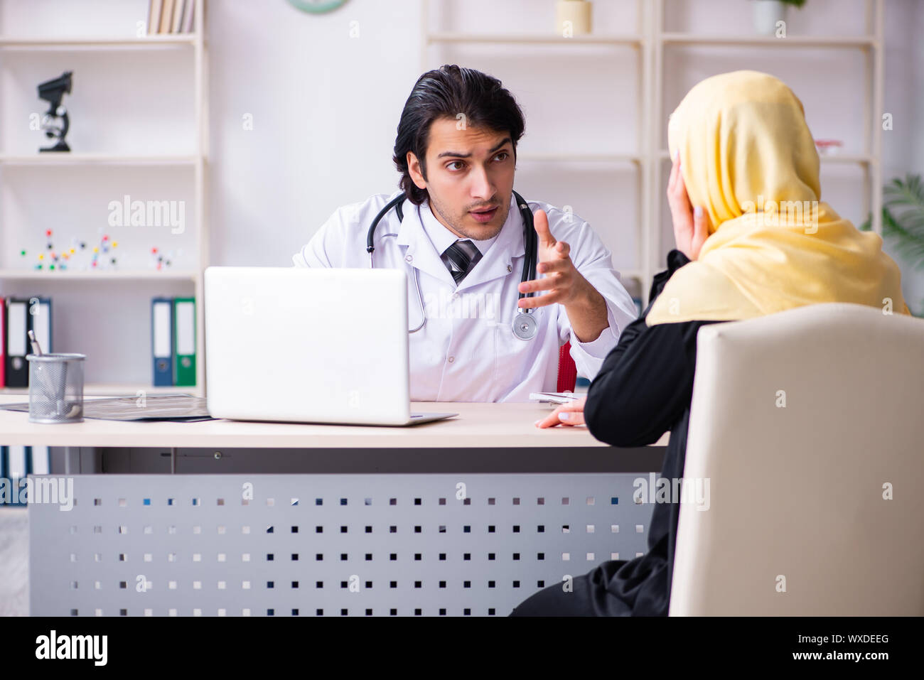 Female arab patient visiting male doctor Stock Photo - Alamy