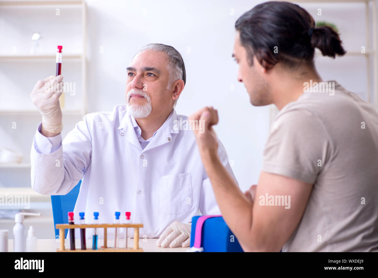 Young handsome man during blood test sampling procedure Stock Photo - Alamy
