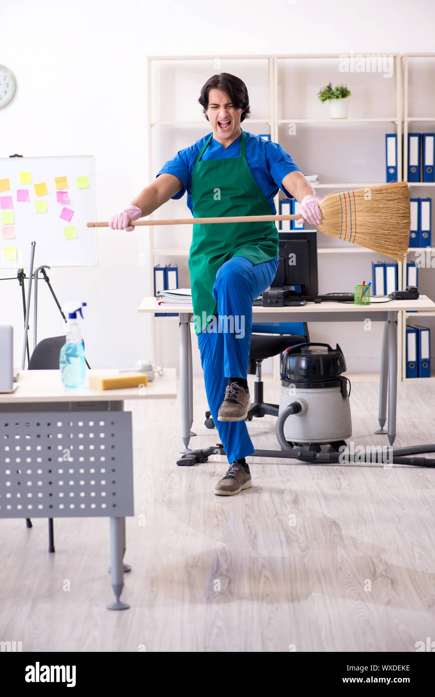 Male handsome professional cleaner working in the office Stock Photo ...