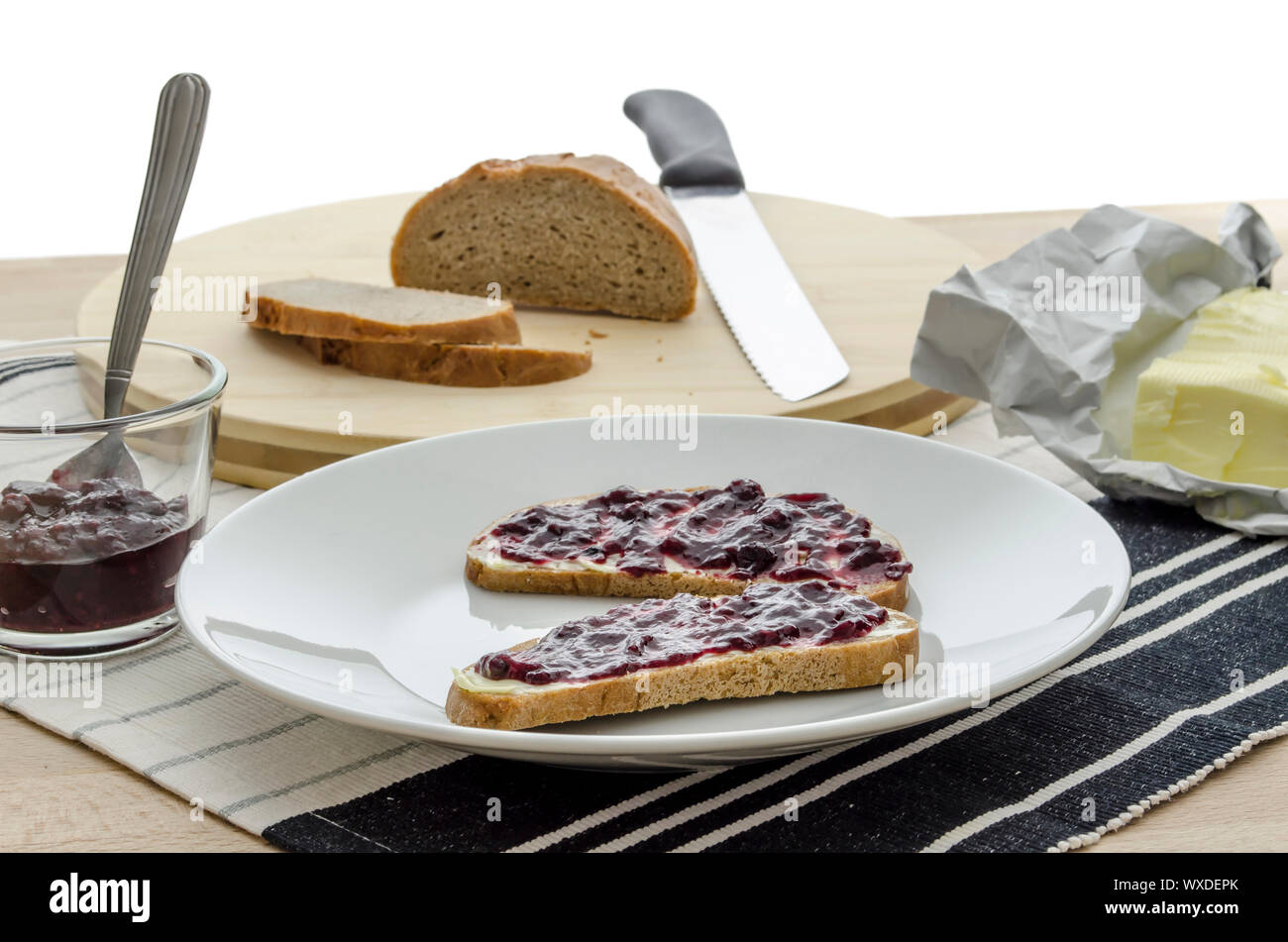 Table ready for breakfast with bread, jam and butter Stock Photo - Alamy