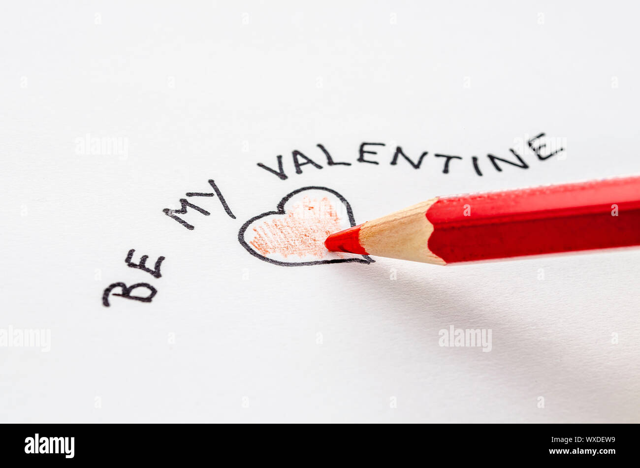 Red pencil writing a Be my Valentine note on a white paper Stock Photo ...
