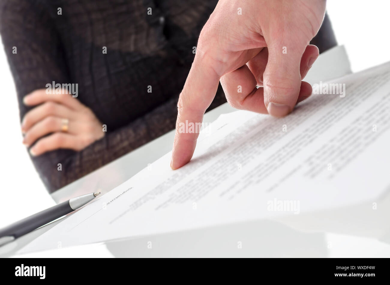 Male hand showing a woman where to sign a paper Stock Photo - Alamy