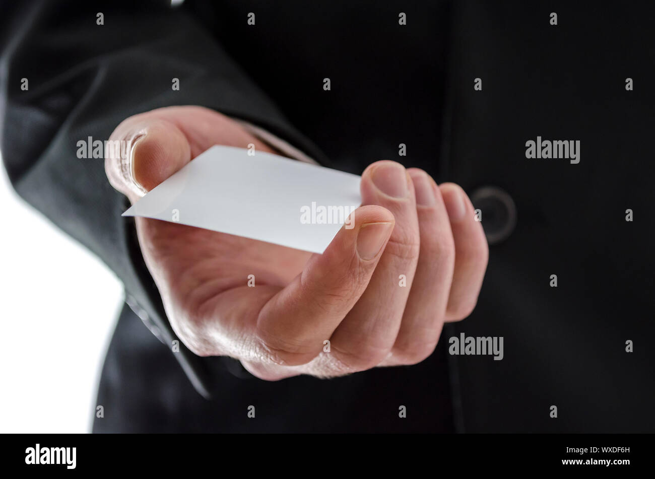 Closeup of a business man giving a blank visit card Stock Photo - Alamy