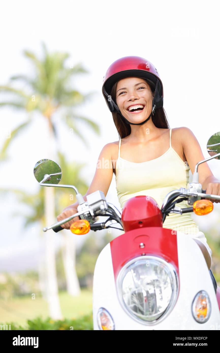 Free woman riding scooter happy. Beautiful asian woman joyful going on ...