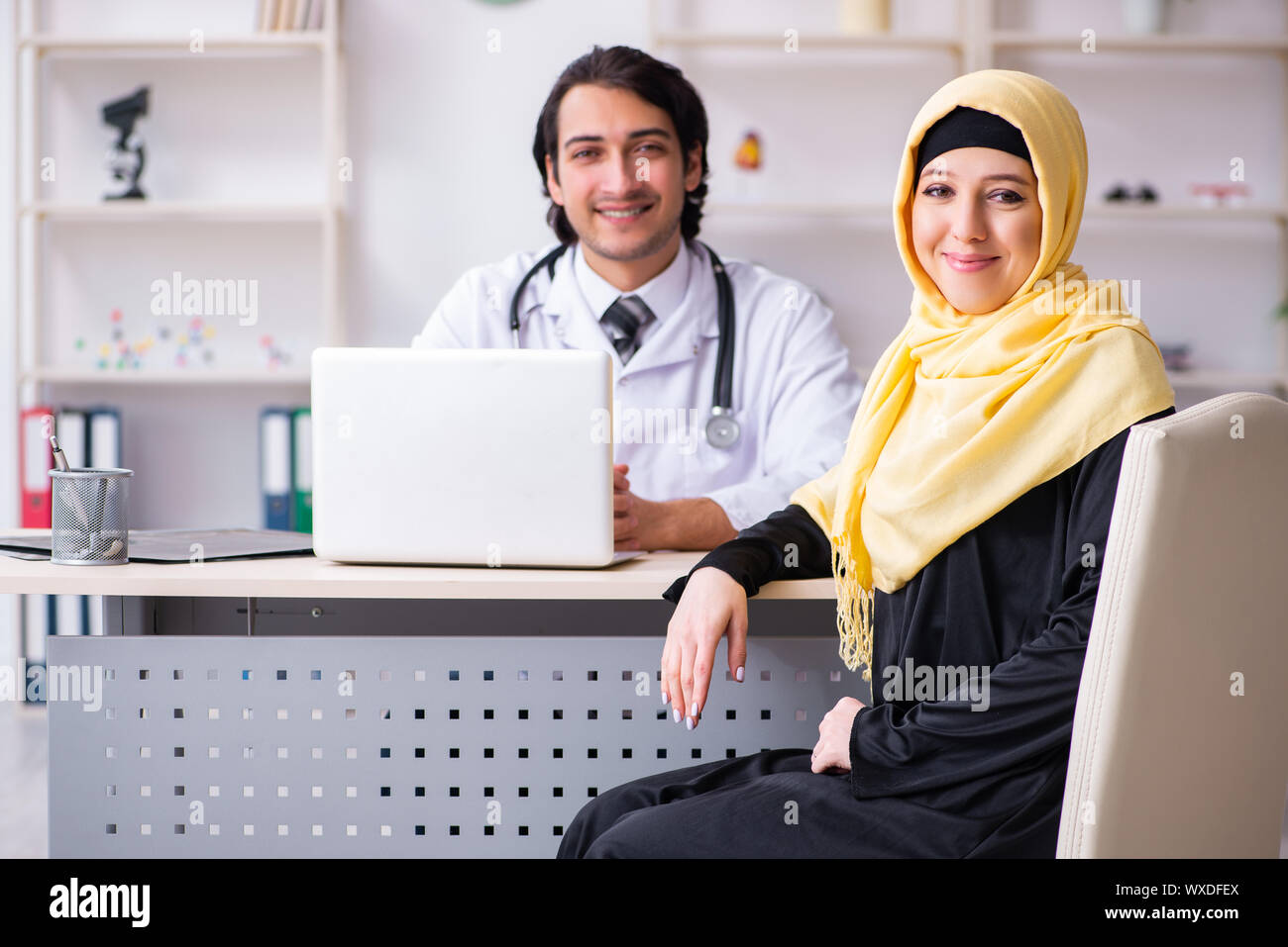 Female arab patient visiting male doctor Stock Photo - Alamy