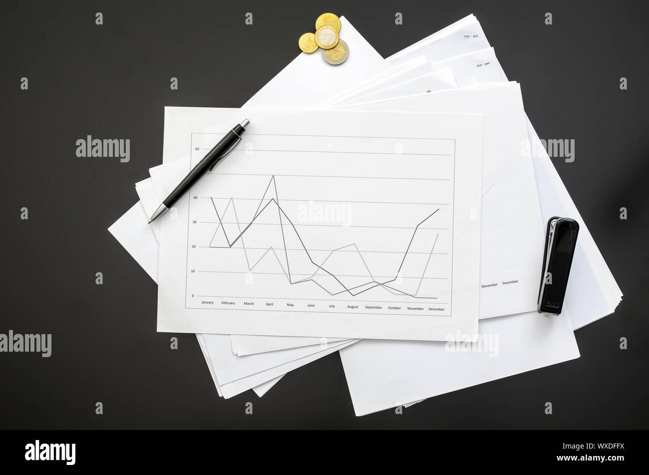 Top view of a graph document on a black office desk Stock Photo - Alamy