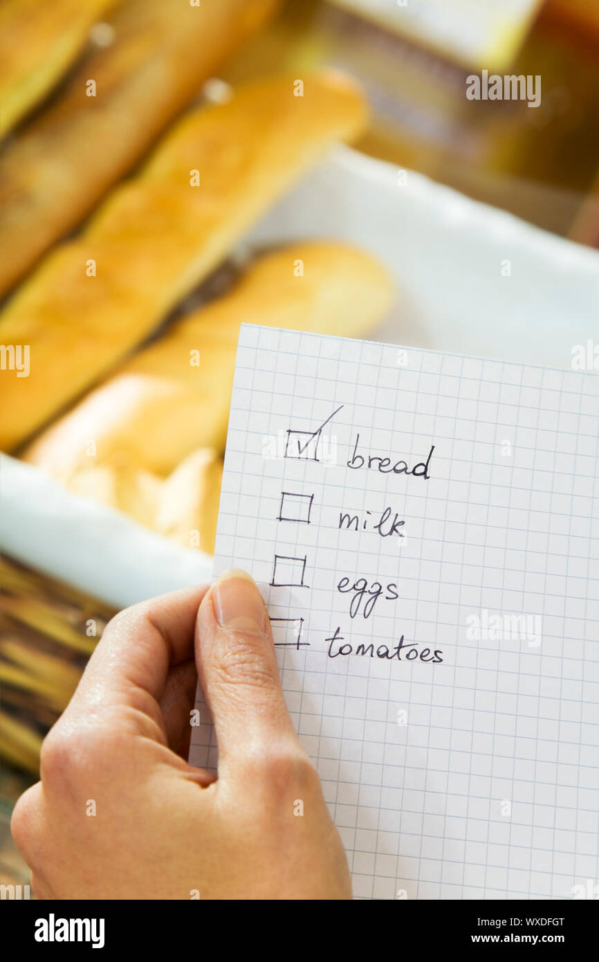 woman in a supermarket checking his shopping list Stock Photo - Alamy