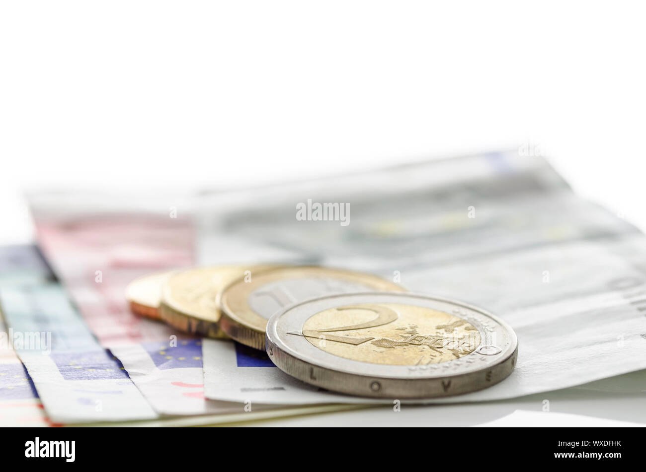 Side view of Euro coins on banknotes Stock Photo - Alamy
