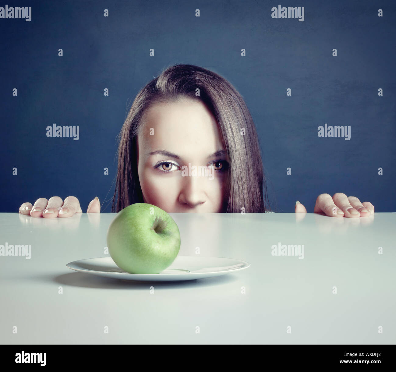 Beautiful woman with apple in front of her Stock Photo - Alamy
