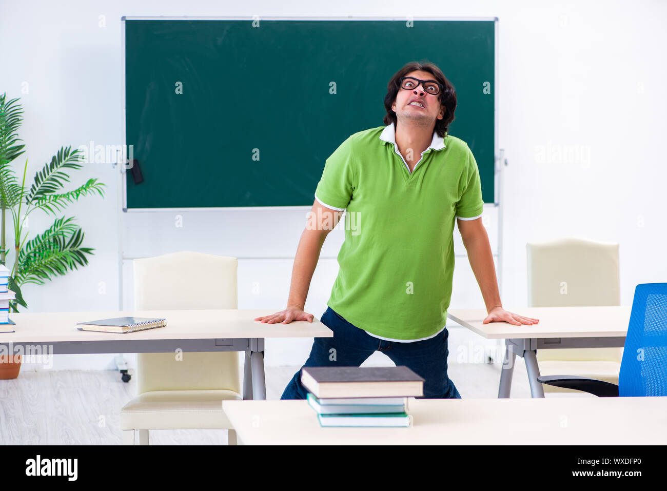 Young student doing physical exercises in the classroom Stock Photo - Alamy