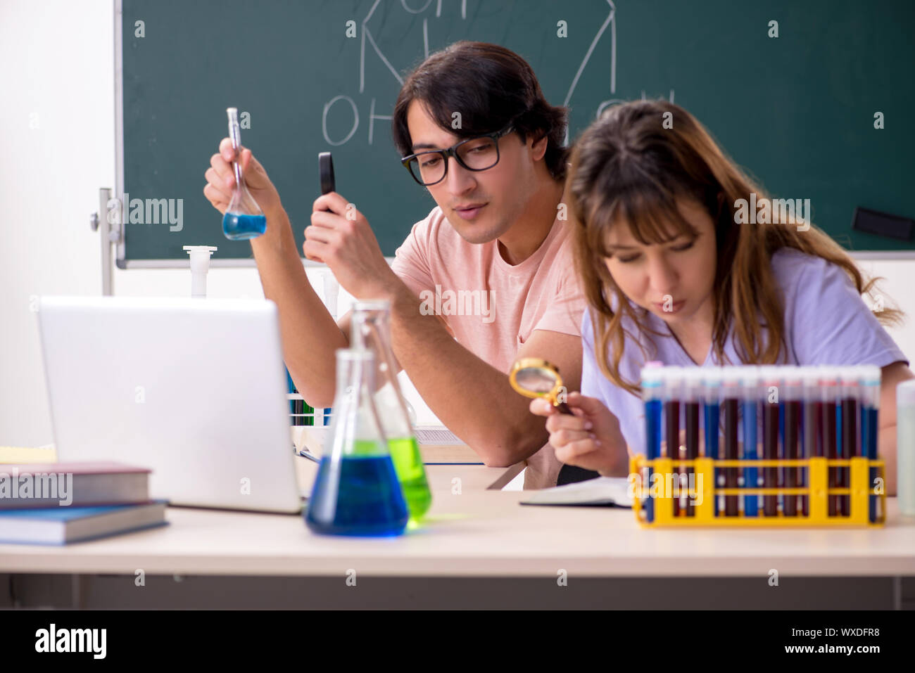 Two chemists students in classroom Stock Photo - Alamy