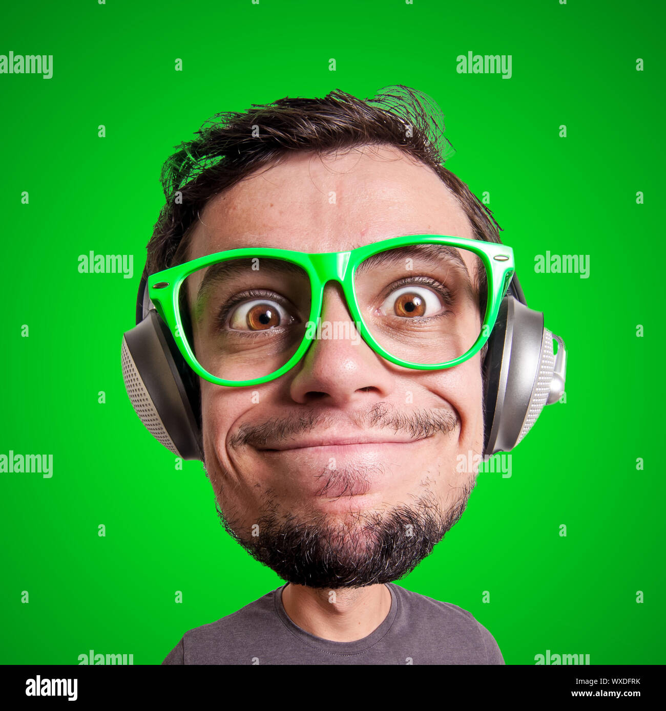 puppet man listening to music with big head on green background Stock ...