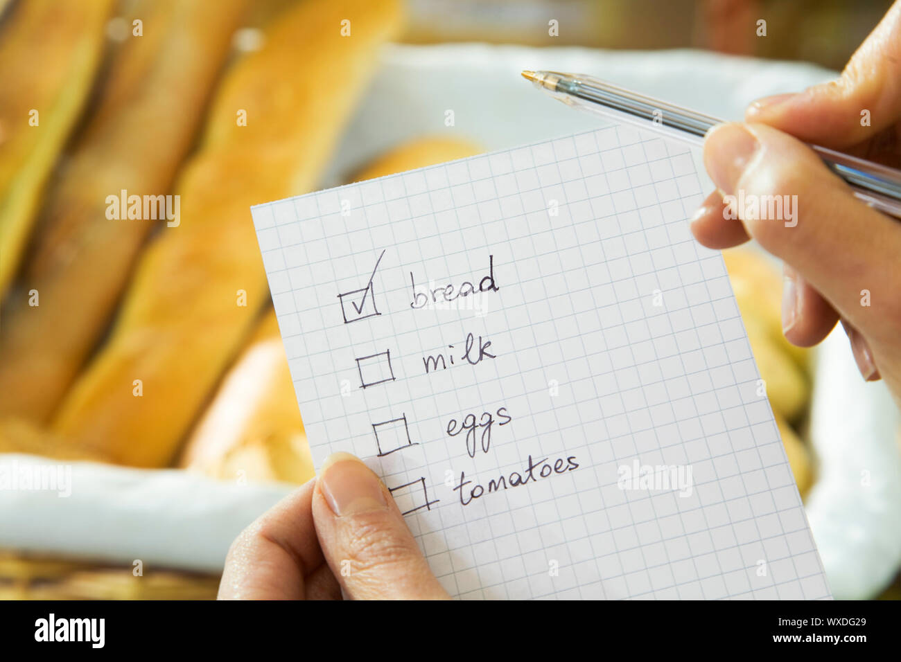 woman in a supermarket checking his shopping list Stock Photo - Alamy